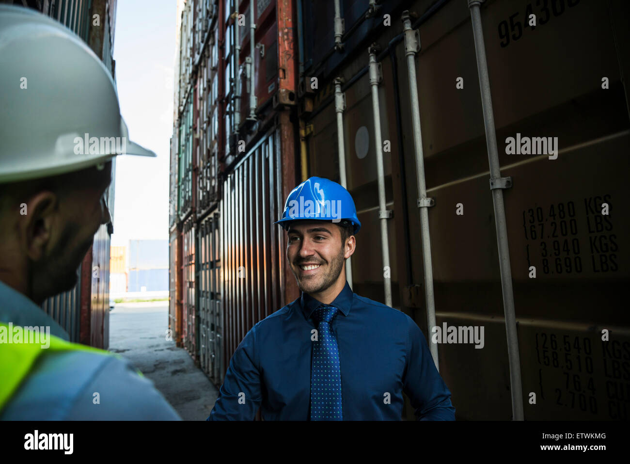 Two men with safety helmets at container port Stock Photo - Alamy