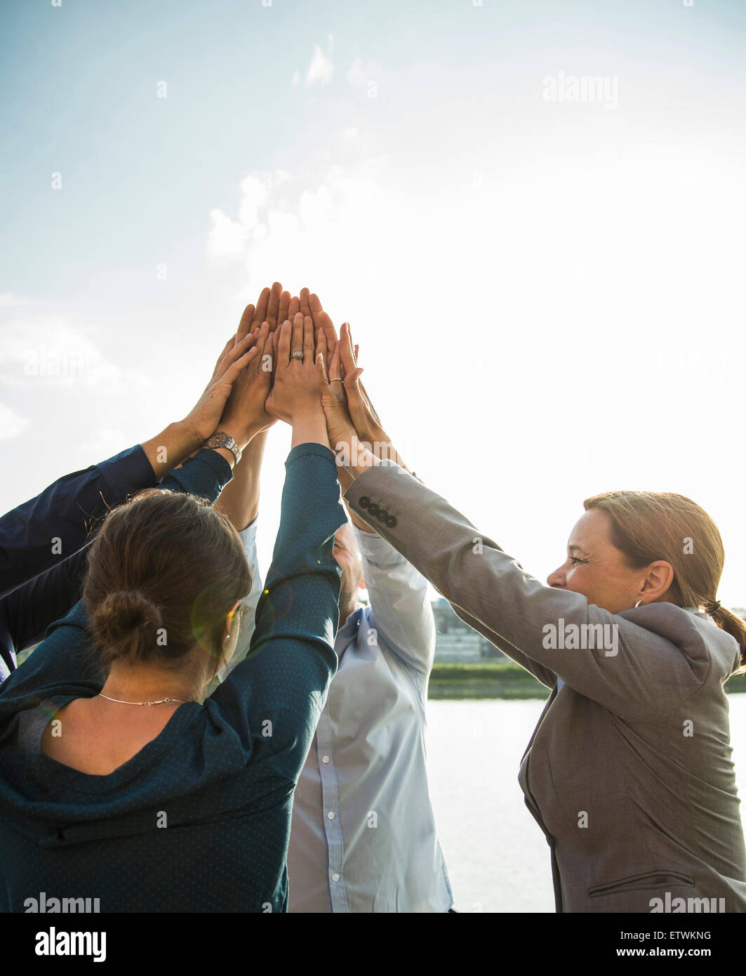 Four raised hands hi-res stock photography and images - Alamy