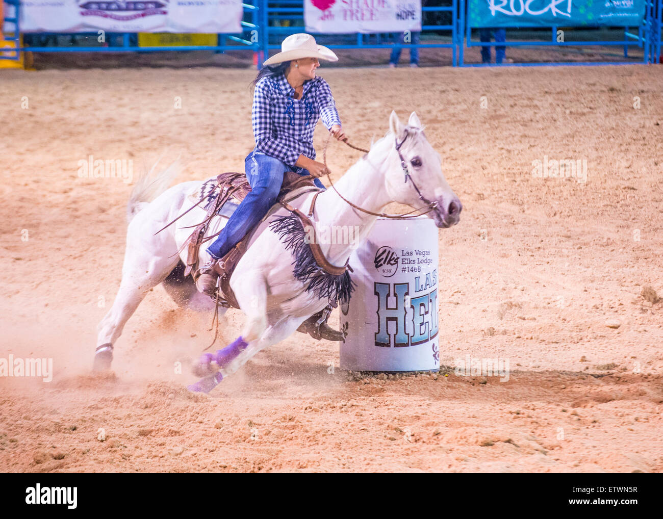 Cowgirl Participating in a Barrel racing competition at the Helldorado ...