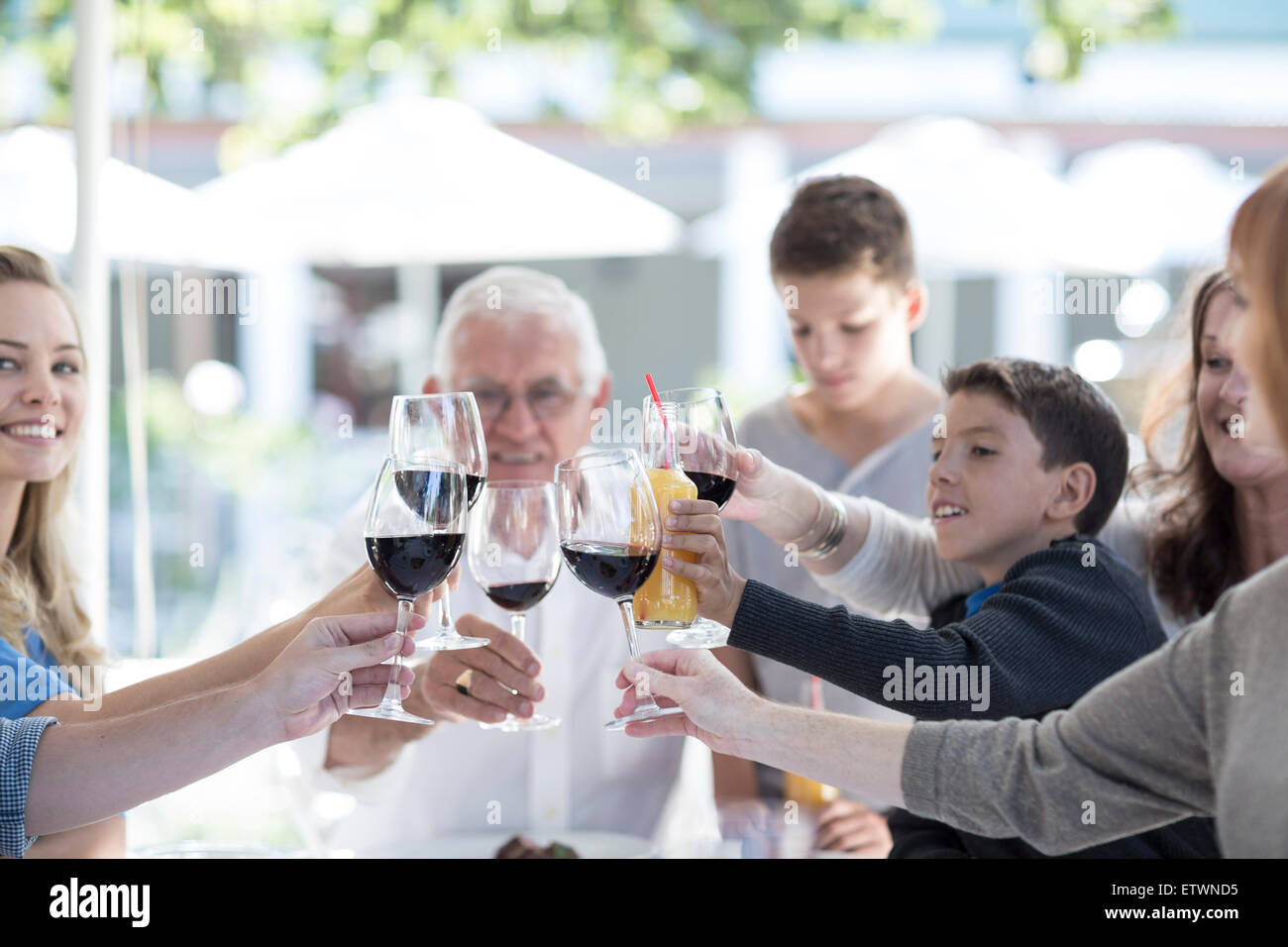 Extended family drinking red wine at restaurant Stock Photo - Alamy
