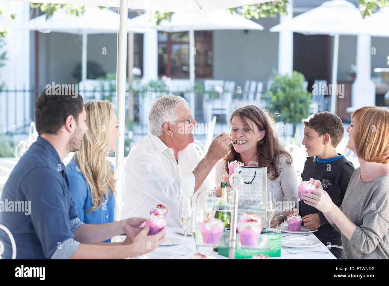 Three generations family celebrating grandfather's birthday at ...