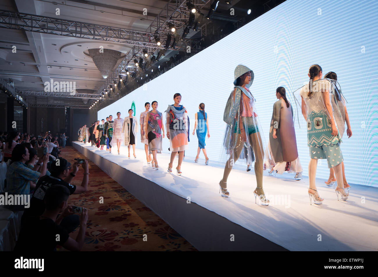 Wuhan, China. 16th June, 2015. Models walk down catwalk at a BA student ...