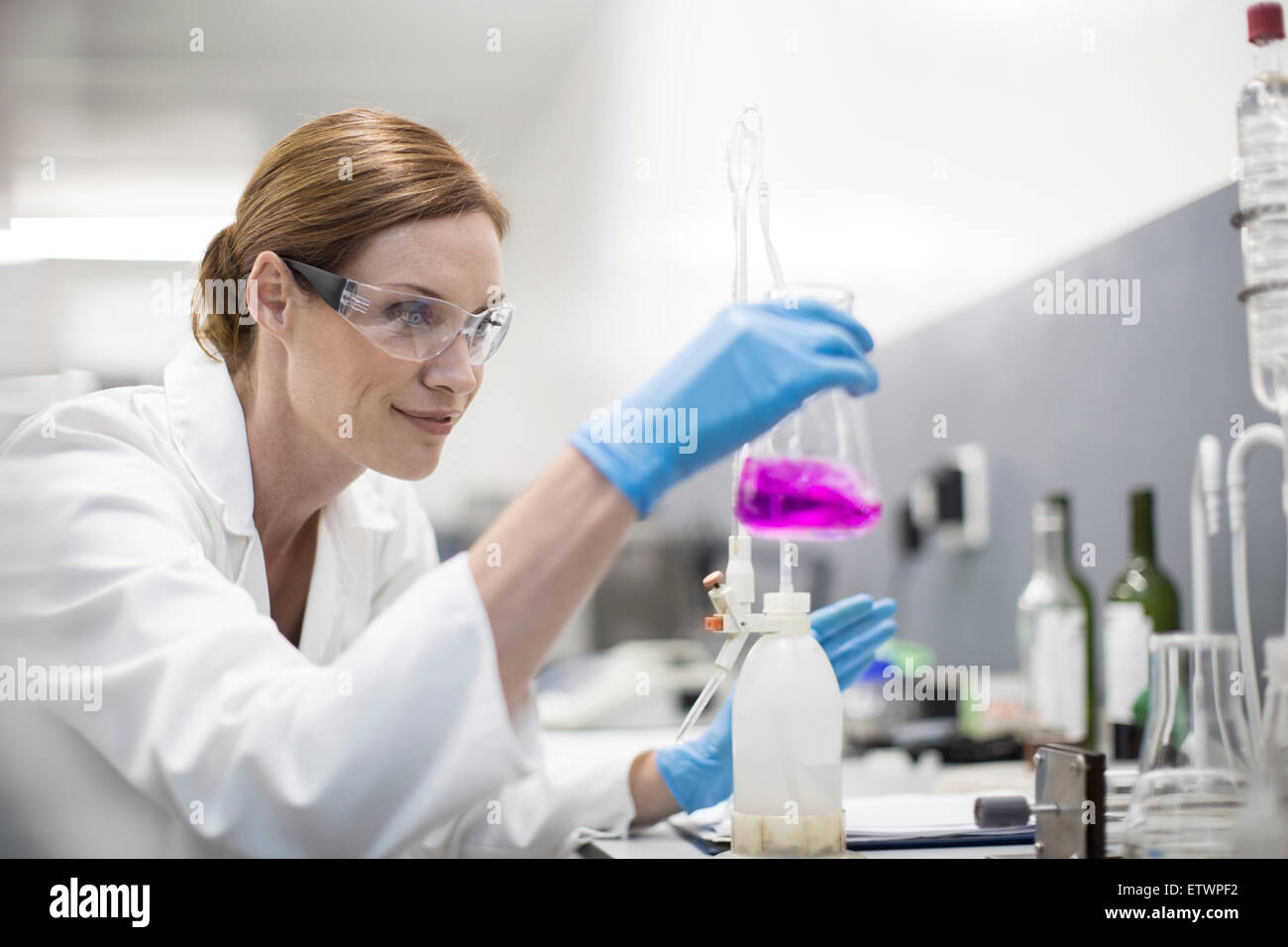 Scientist in lab holding Erlenmeyer flask Stock Photo - Alamy