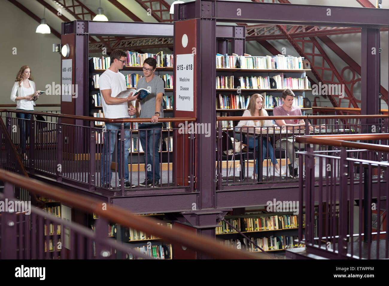 Five students in a library Stock Photo - Alamy
