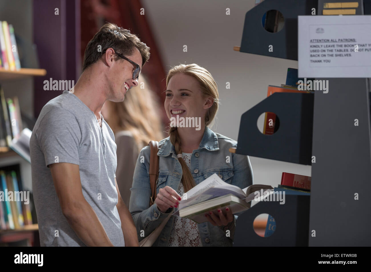 Two students in a library Stock Photo - Alamy