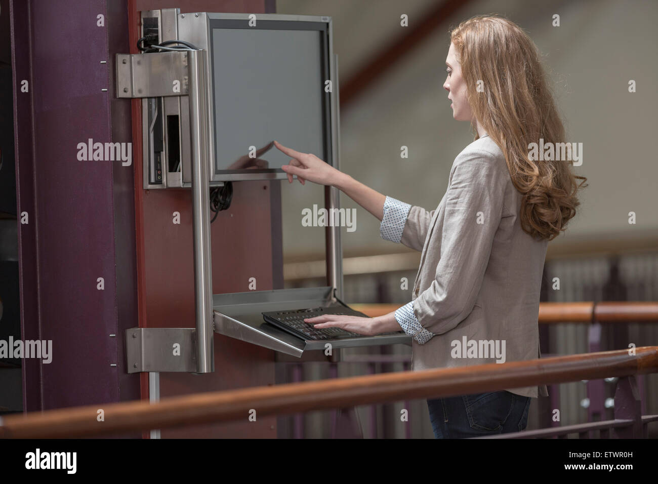 Female student using touch screen in a library Stock Photo - Alamy