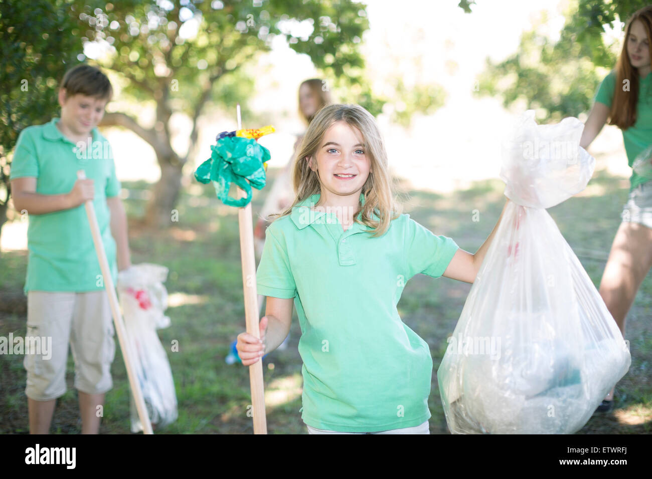Children picking up garbage in a park Stock Photo - Alamy