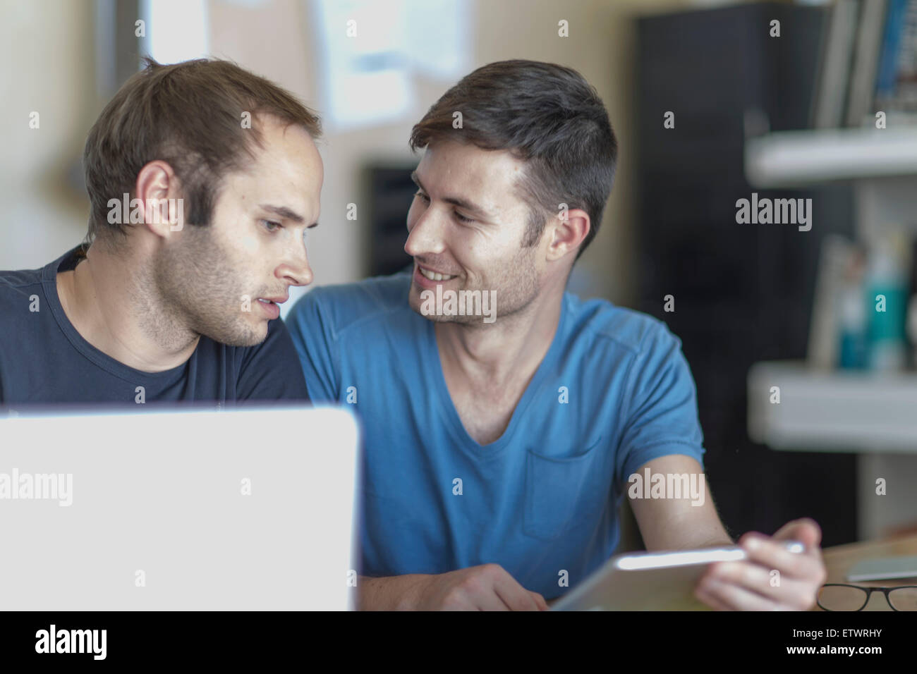 Two men with laptop and digital tablet Stock Photo - Alamy