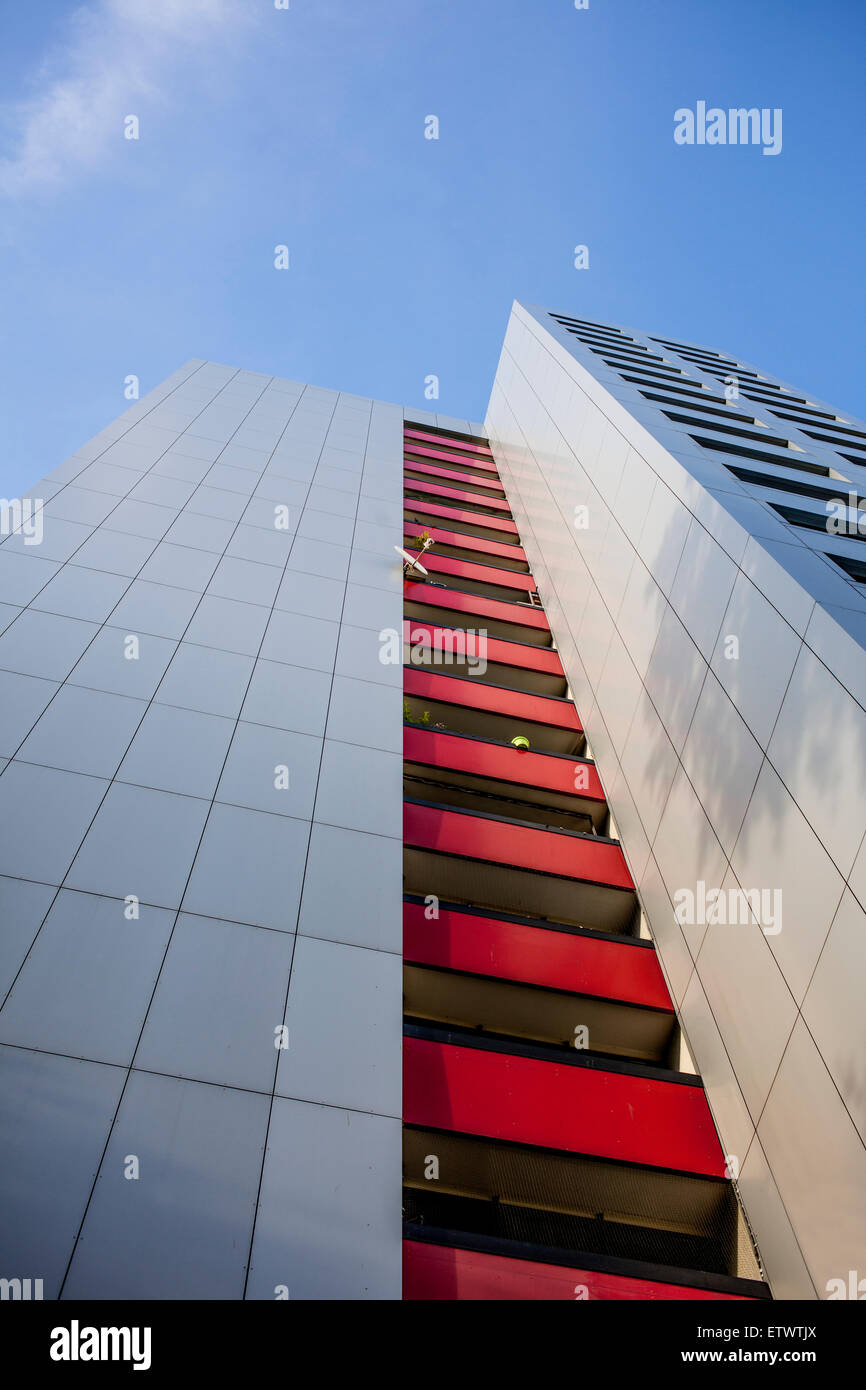 Refurbished high-rise residential building with red balconies Stock ...