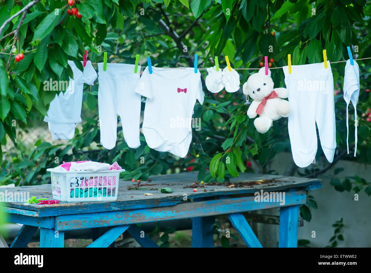 baby clothes on rope in the garden Stock Photo - Alamy