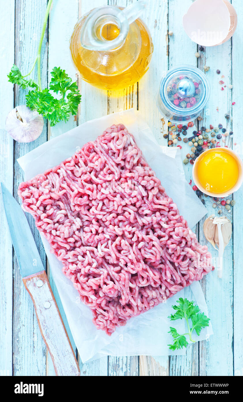 raw minced meat with spice and salt on a table Stock Photo - Alamy