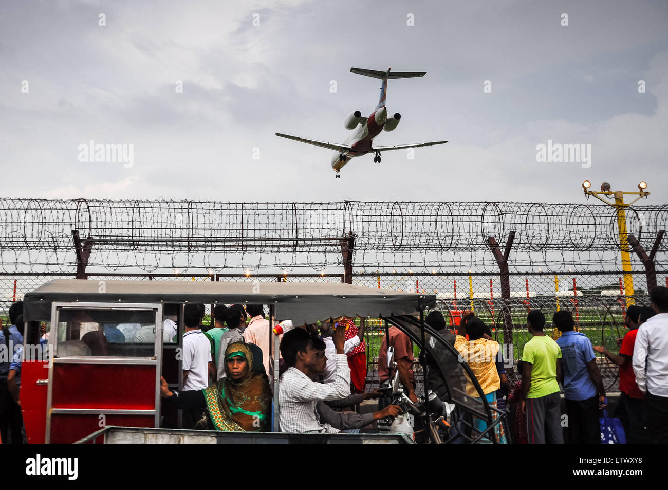 Dhaka, Bangladesh. 16th June, 2015. People are watching airplane flying ...