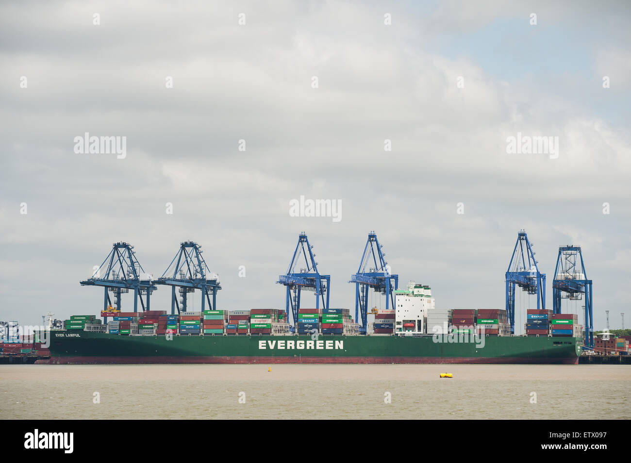 Felixstowe shipping port docks with massive cranes loading large ...