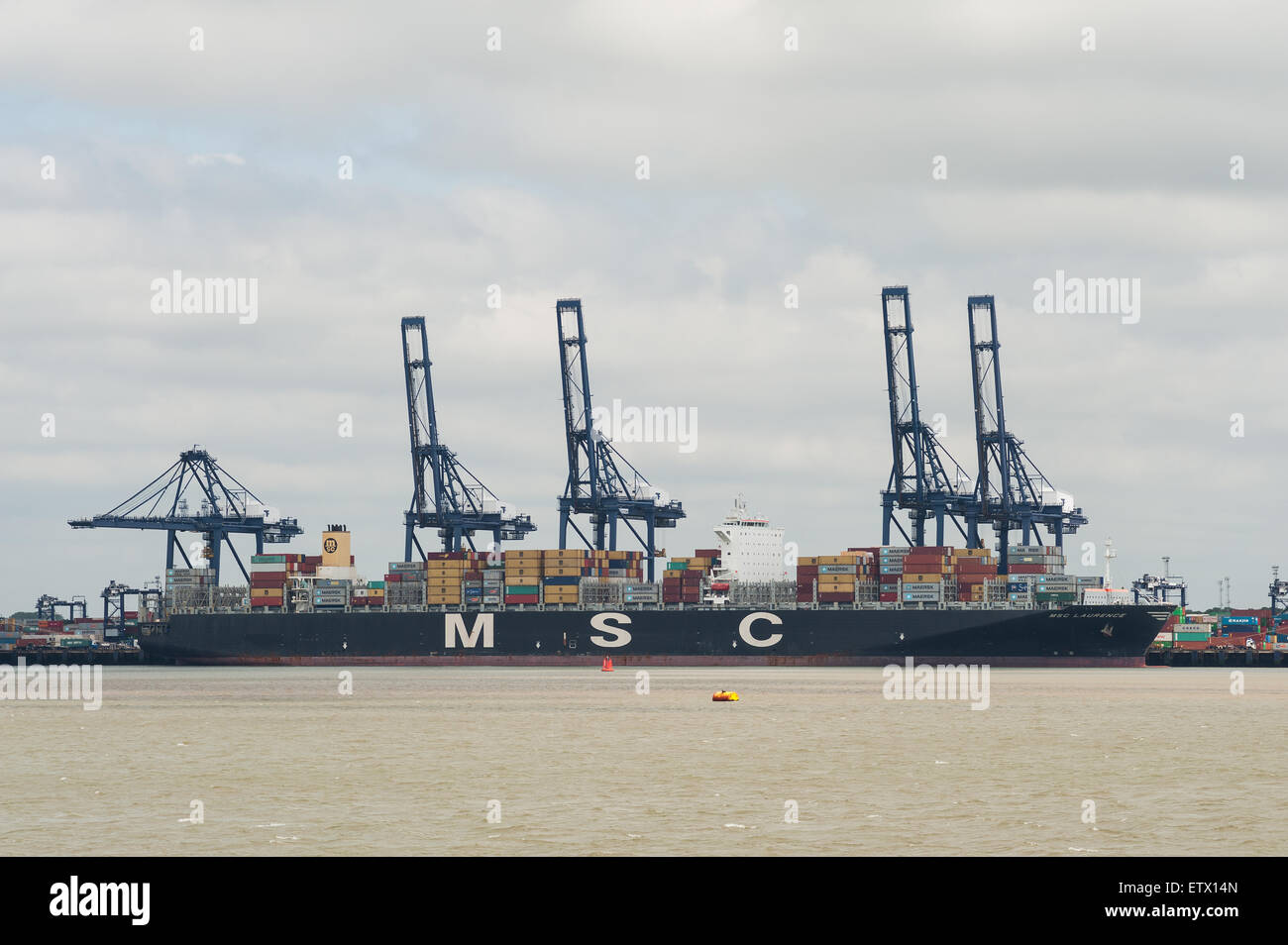 Felixstowe shipping port docks with massive cranes loading large ...