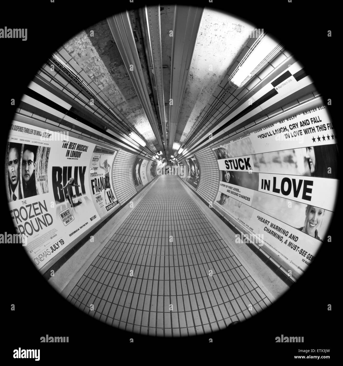 Fish-eye view of underground tunnel with advertising posters Stock ...