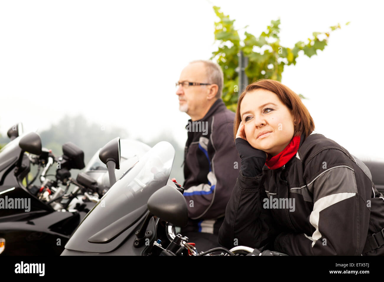 Two motorcyclists taking a break Stock Photo - Alamy