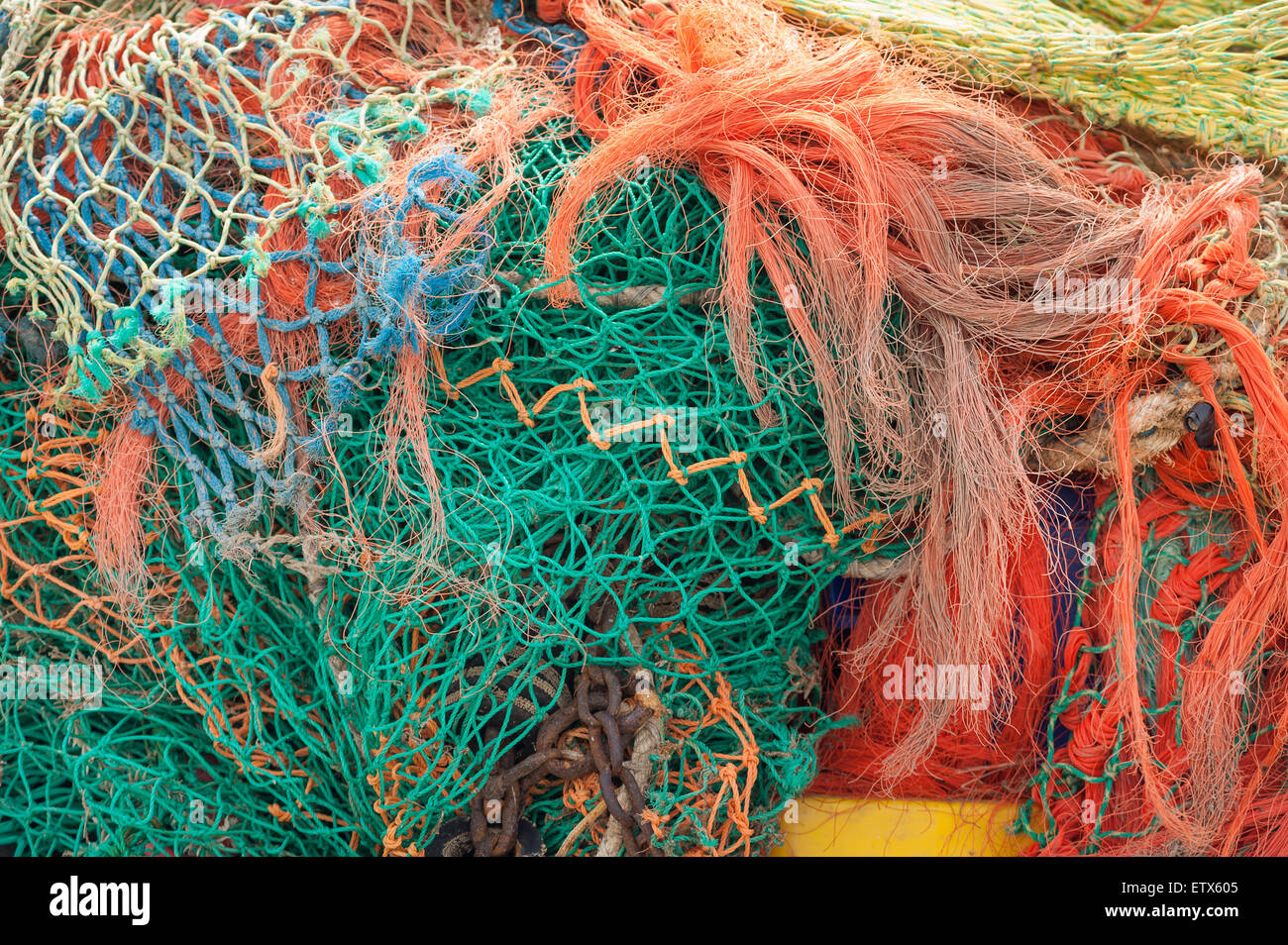 Mass of dry weathered fishing nets with mesh of different sizes a ...