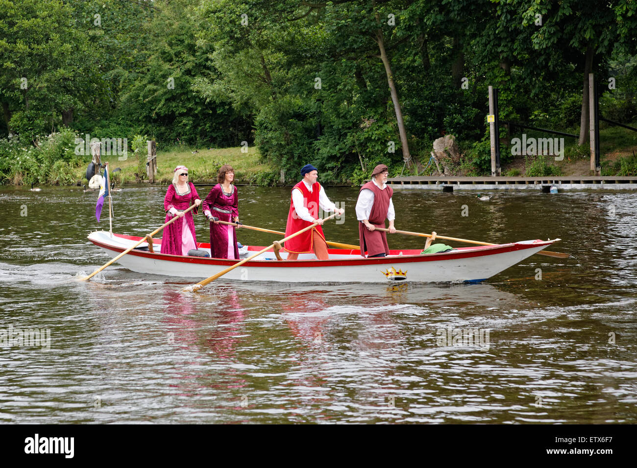 Rowers in 'medieval' costume propel their boat to join a flotilla in ...