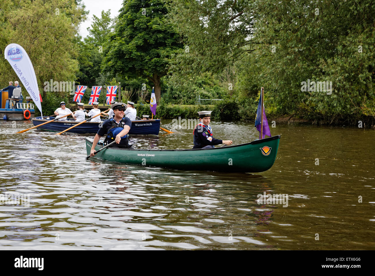 On the River Thames at Runnymede sea scouts paddle a canoe downstream ...