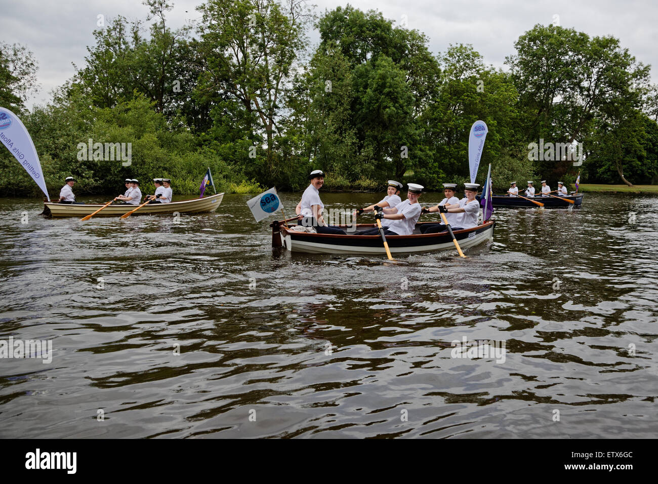On the River Thames at Runnymede three row boats with all female crew ...