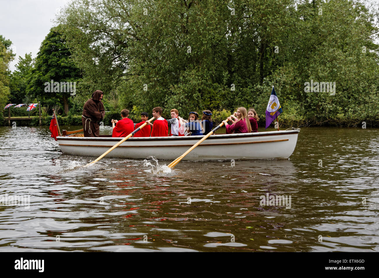 The River Thames at Runnymede. A group of boys and girls in costume row ...