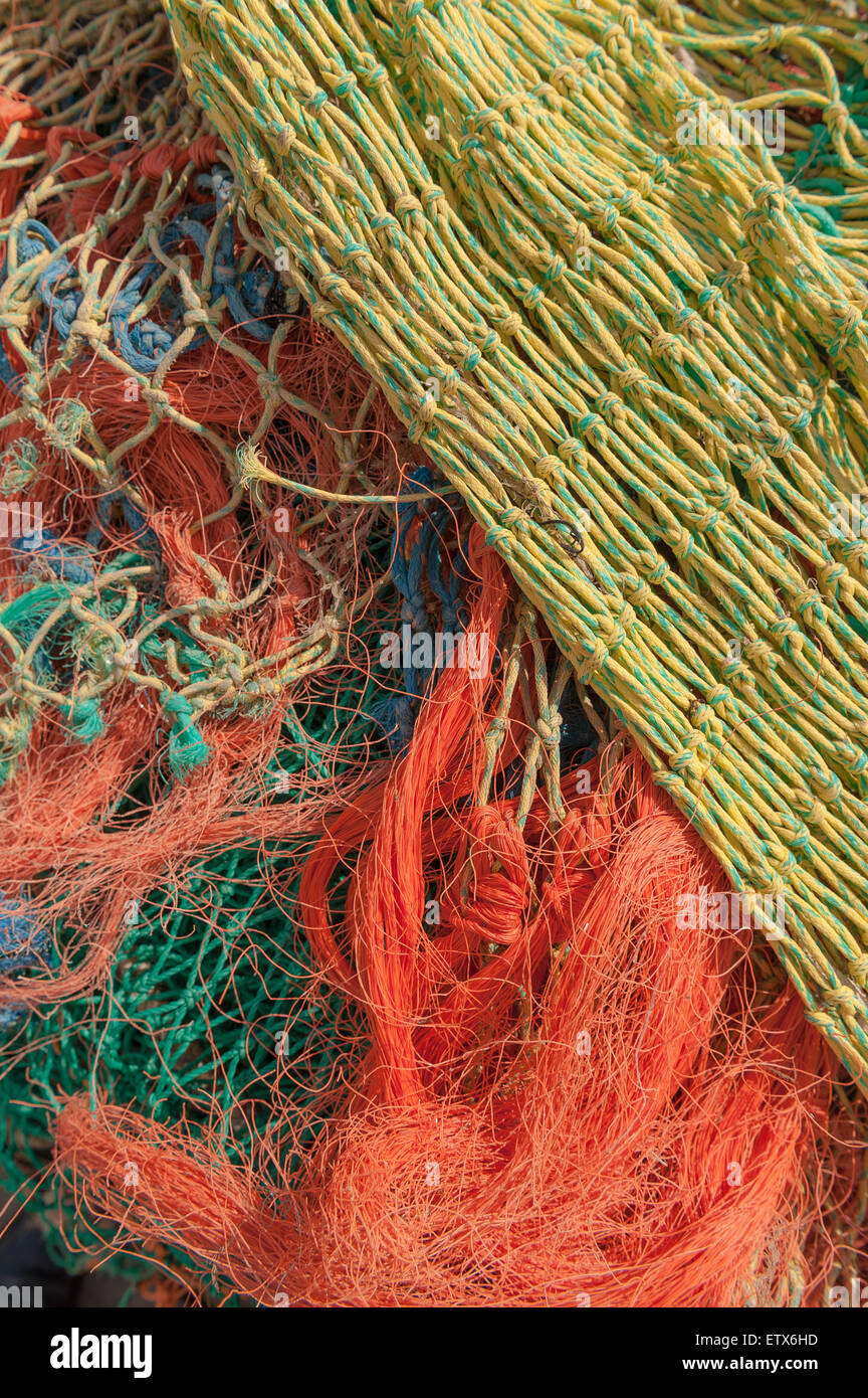 Mass of dry weathered fishing nets with mesh of different sizes a ...