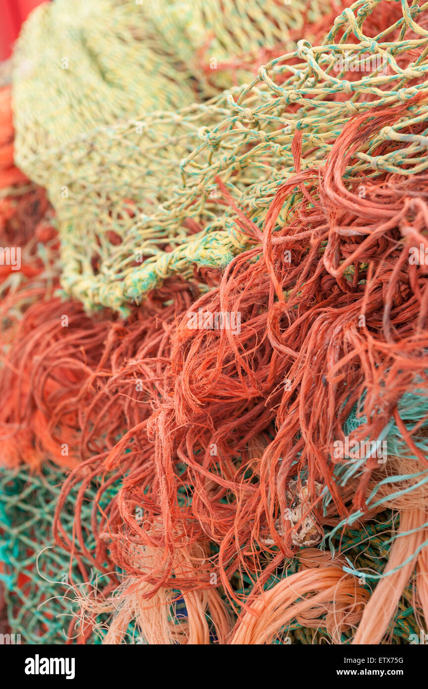 Mass of dry weathered fishing nets with mesh of different sizes a ...