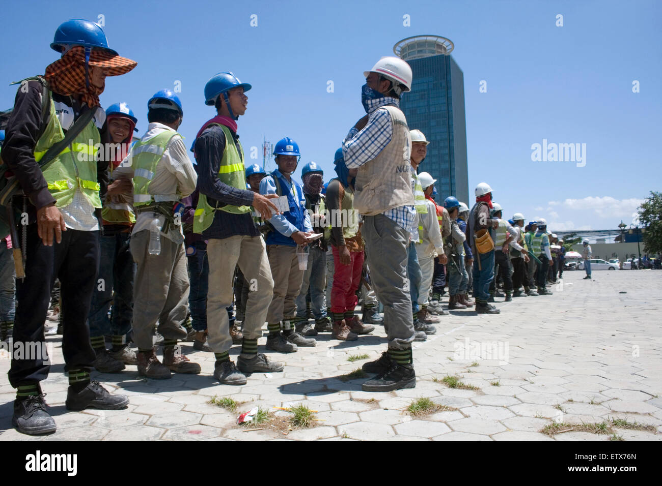 Construction workers take part in stretching exercises to enhance ...