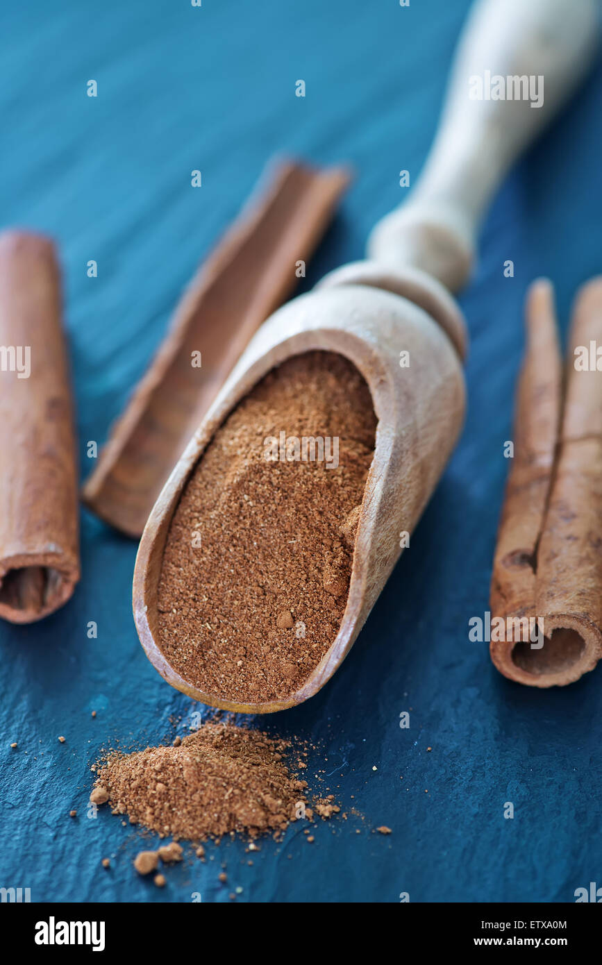 cinnamon in wooden spoon and on a table Stock Photo - Alamy