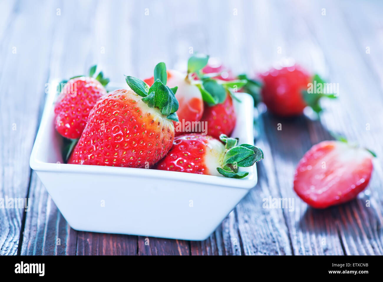 fresh strawberry in bowl and on a table Stock Photo - Alamy