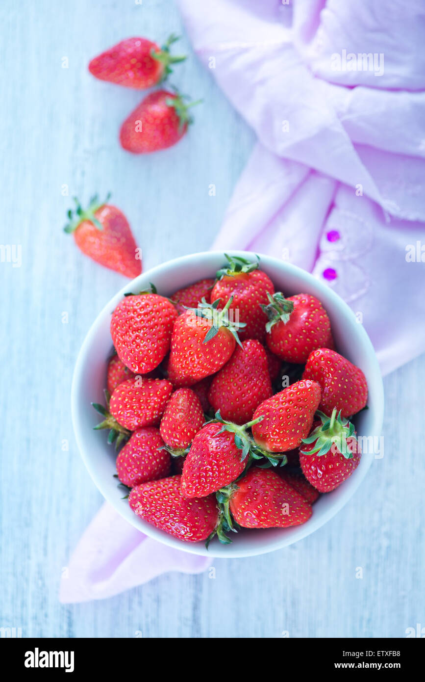 fresh strawberry in bowl and on a table Stock Photo - Alamy