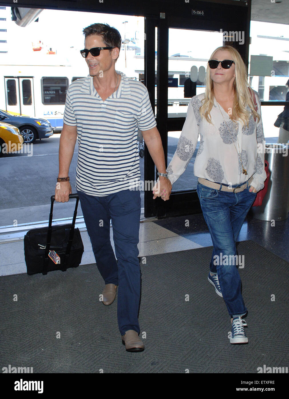 Rob Lowe holds hands with his wife Sheryl Berkoff as they arrive at Los ...