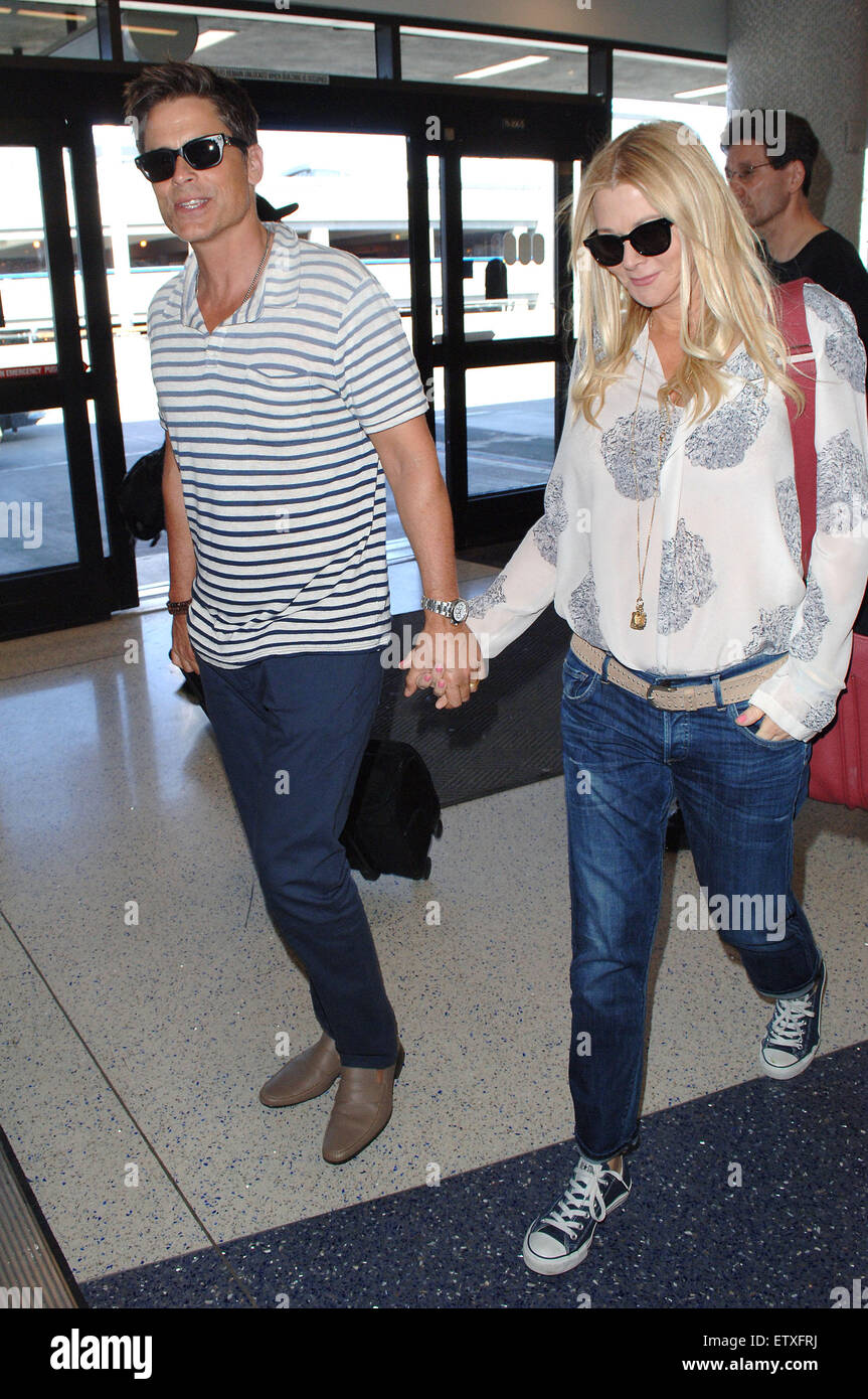 Rob Lowe holds hands with his wife Sheryl Berkoff as they arrive at Los ...