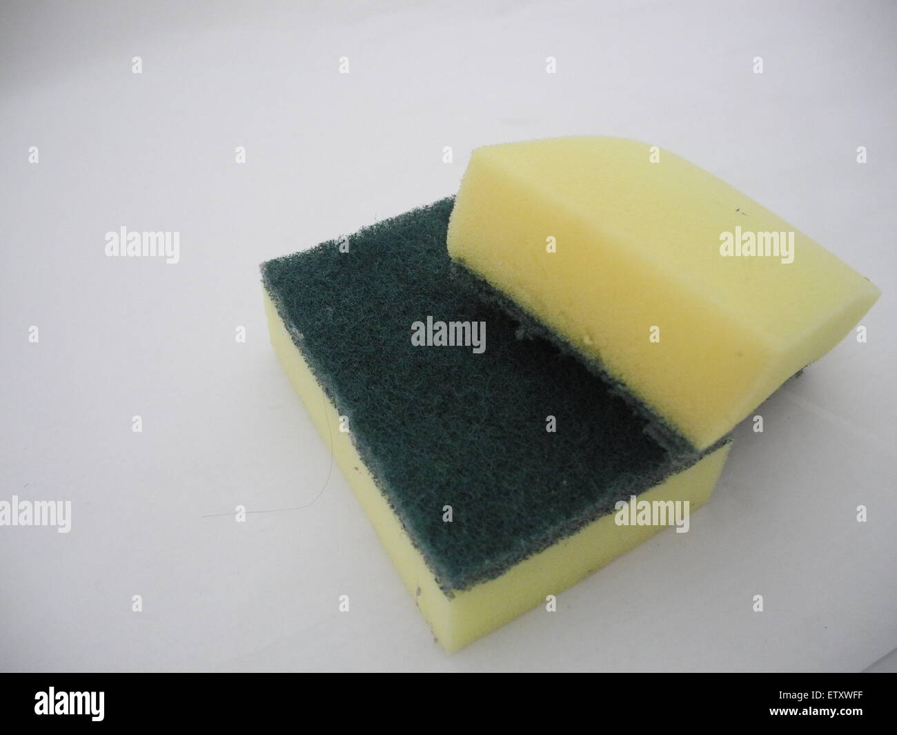 Sponge washing dishes in the kitchen Stock Photo - Alamy