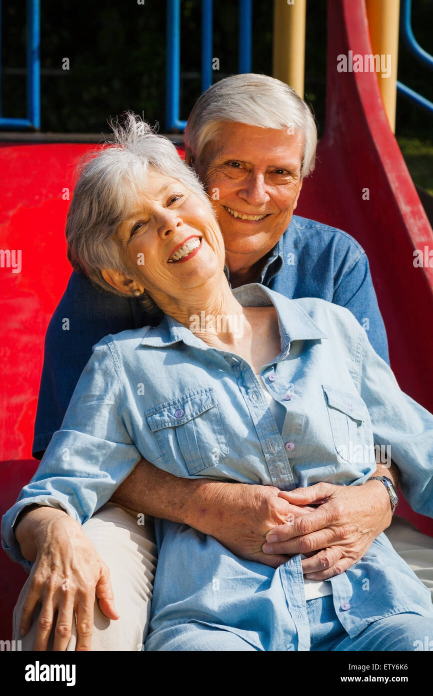 Senior Couple embracing at Playground Stock Photo - Alamy