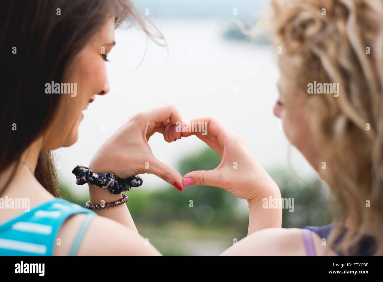 Heart shape made of hands from two best girl friends Stock Photo - Alamy