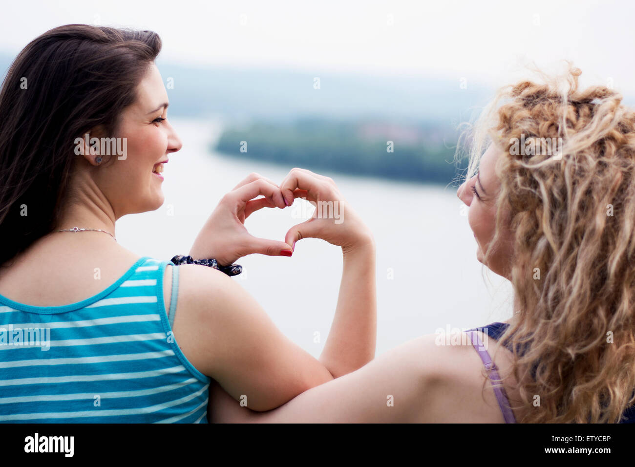 Heart shape made of hands from two best girl friends Stock Photo - Alamy