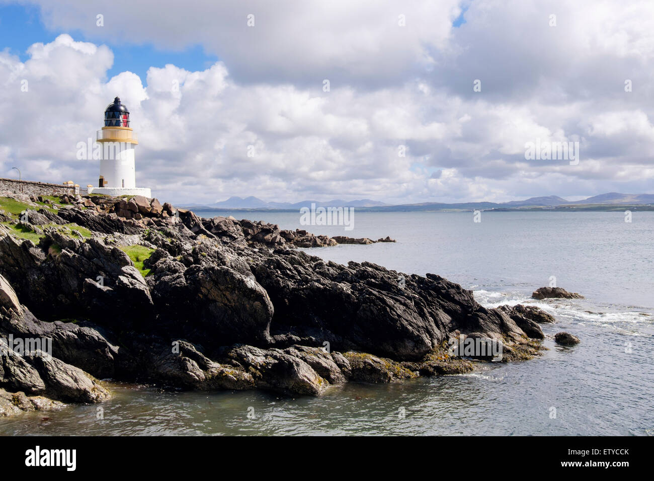 White lighthouse on rocky coast around Loch Indaal at Port Charlotte ...