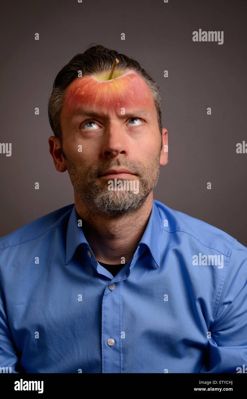 Business man with an apple head on a gray wall Stock Photo - Alamy