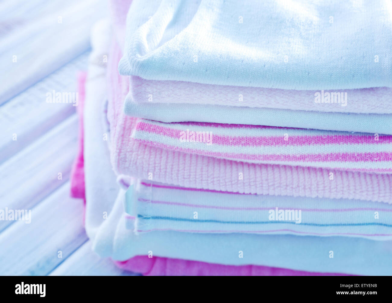 baby clothes on a table, color baby clothes Stock Photo - Alamy
