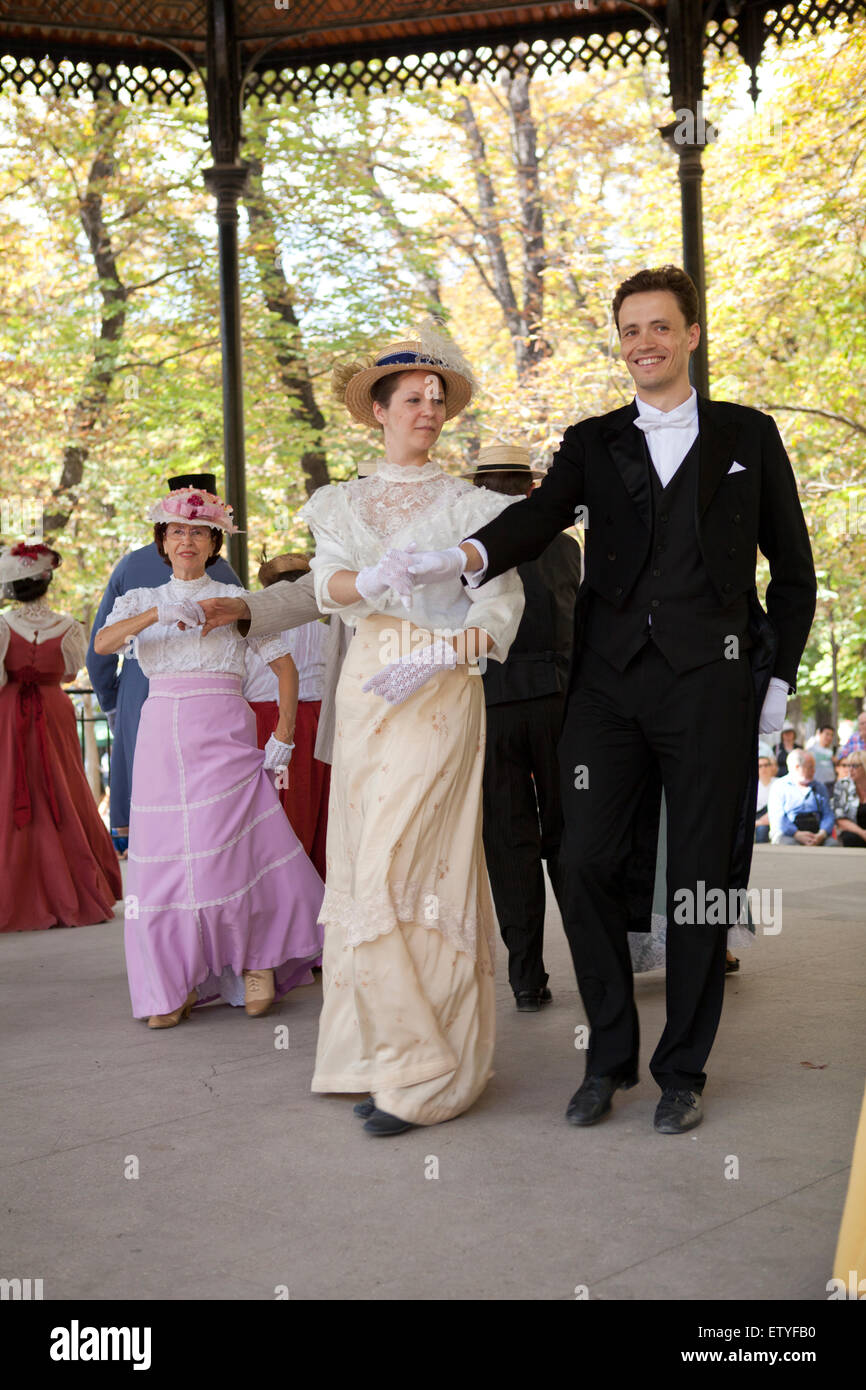 Pair wearing costumes dancing under a porch in the Luxembourg gardens ...