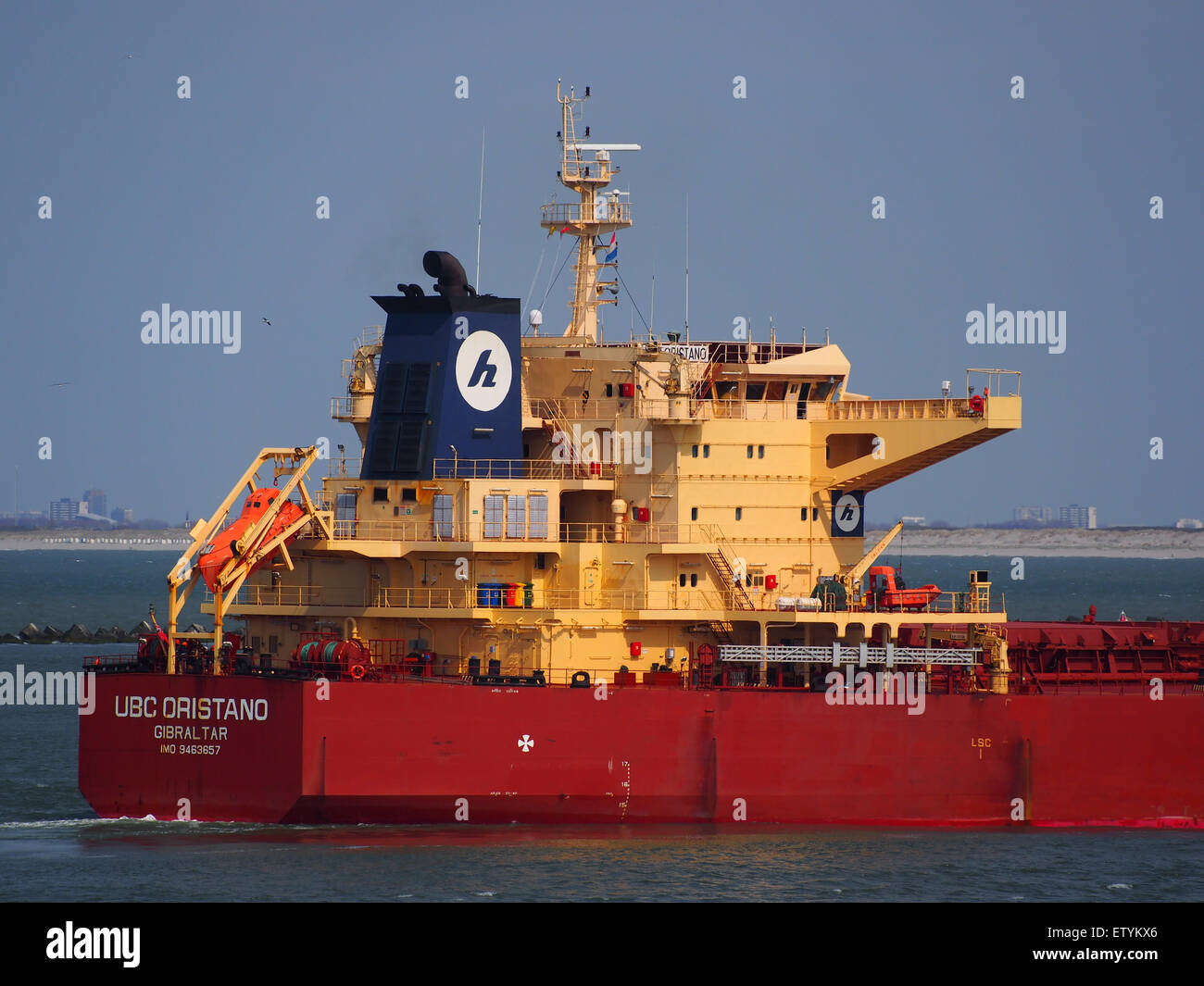The image features the UBC Oristano, an IMO 9463657 tanker ship docked ...