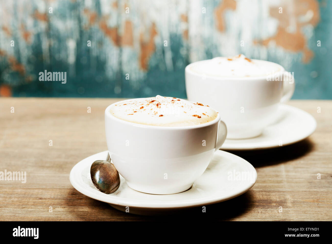 Two cups of coffee on old wooden table Stock Photo - Alamy