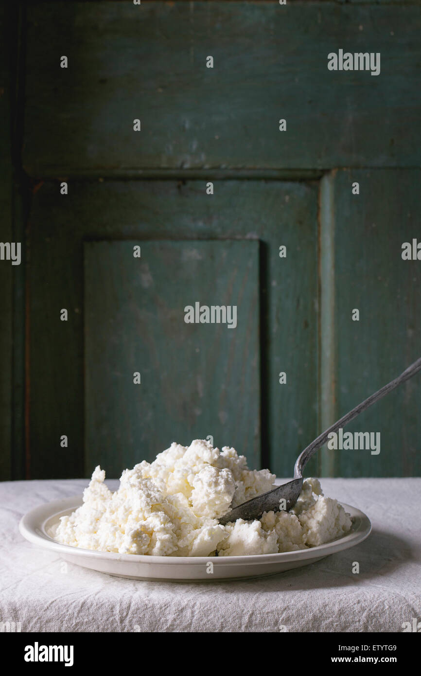 Plate of homemade cottage cheese on white tablecloth with turquoise ...