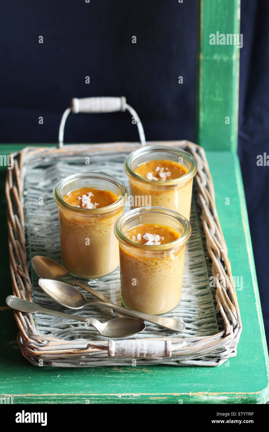 Three salted caramel pots de creme Stock Photo - Alamy