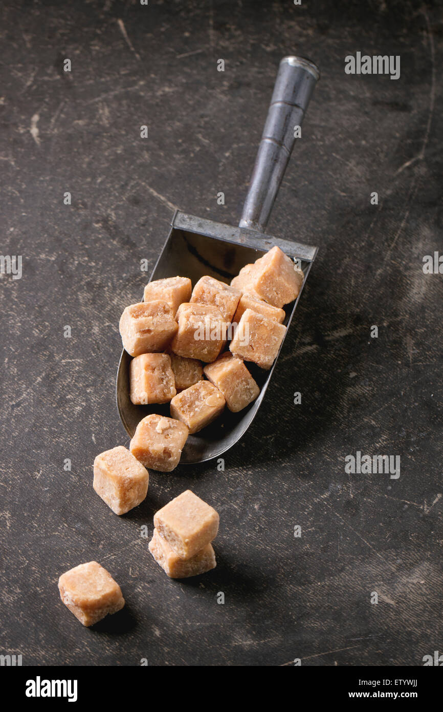 Vintage pastry scoop with fudge candy over dark background Stock Photo ...