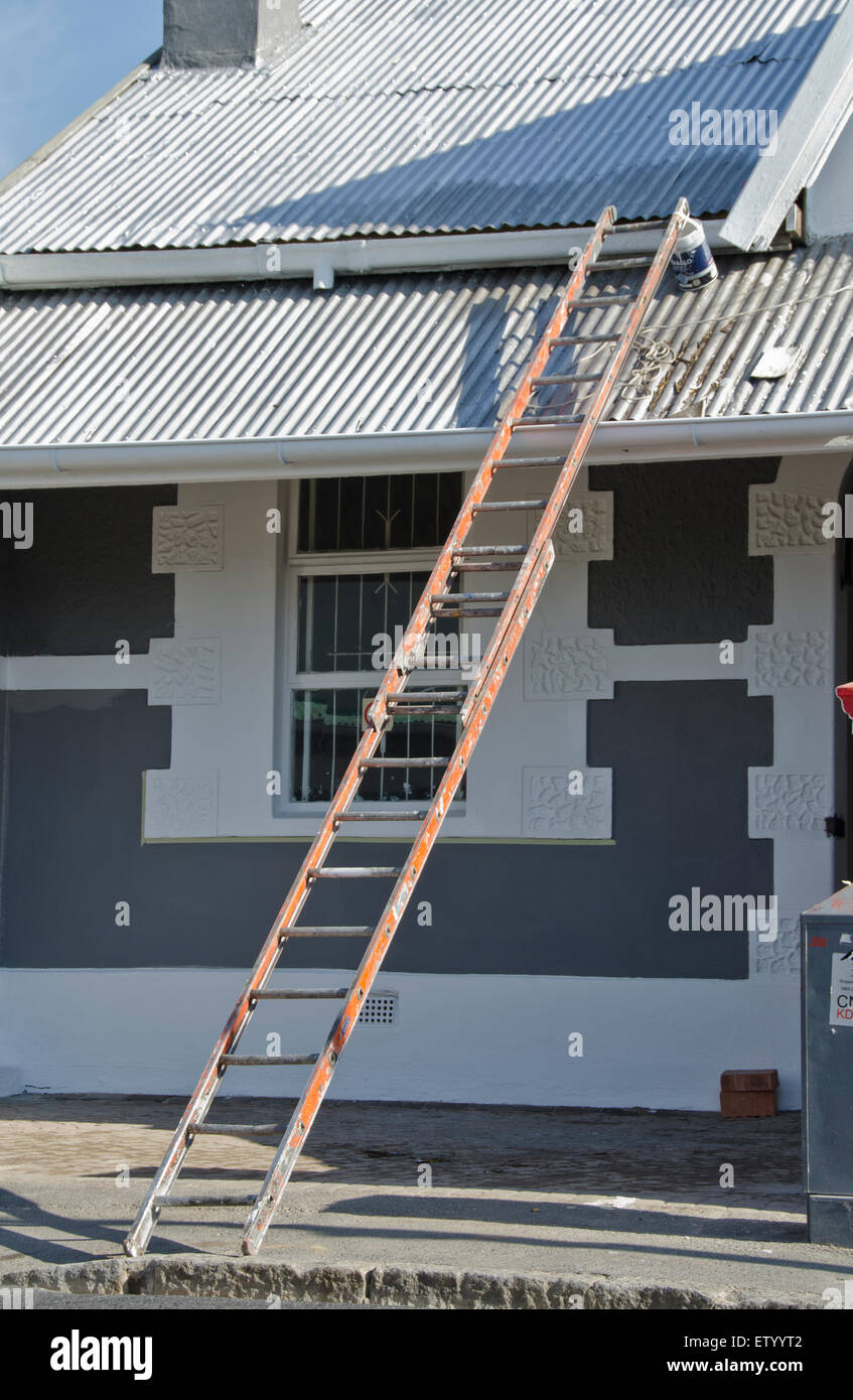 long ladder leaning against a roof of a house Stock Photo - Alamy