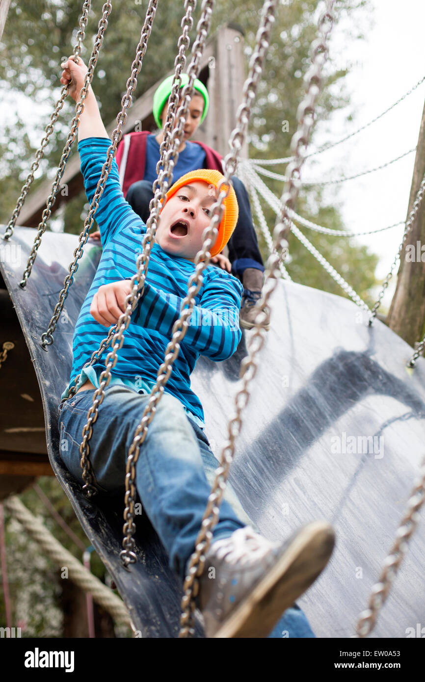two boys playing outside on a playground Stock Photo - Alamy
