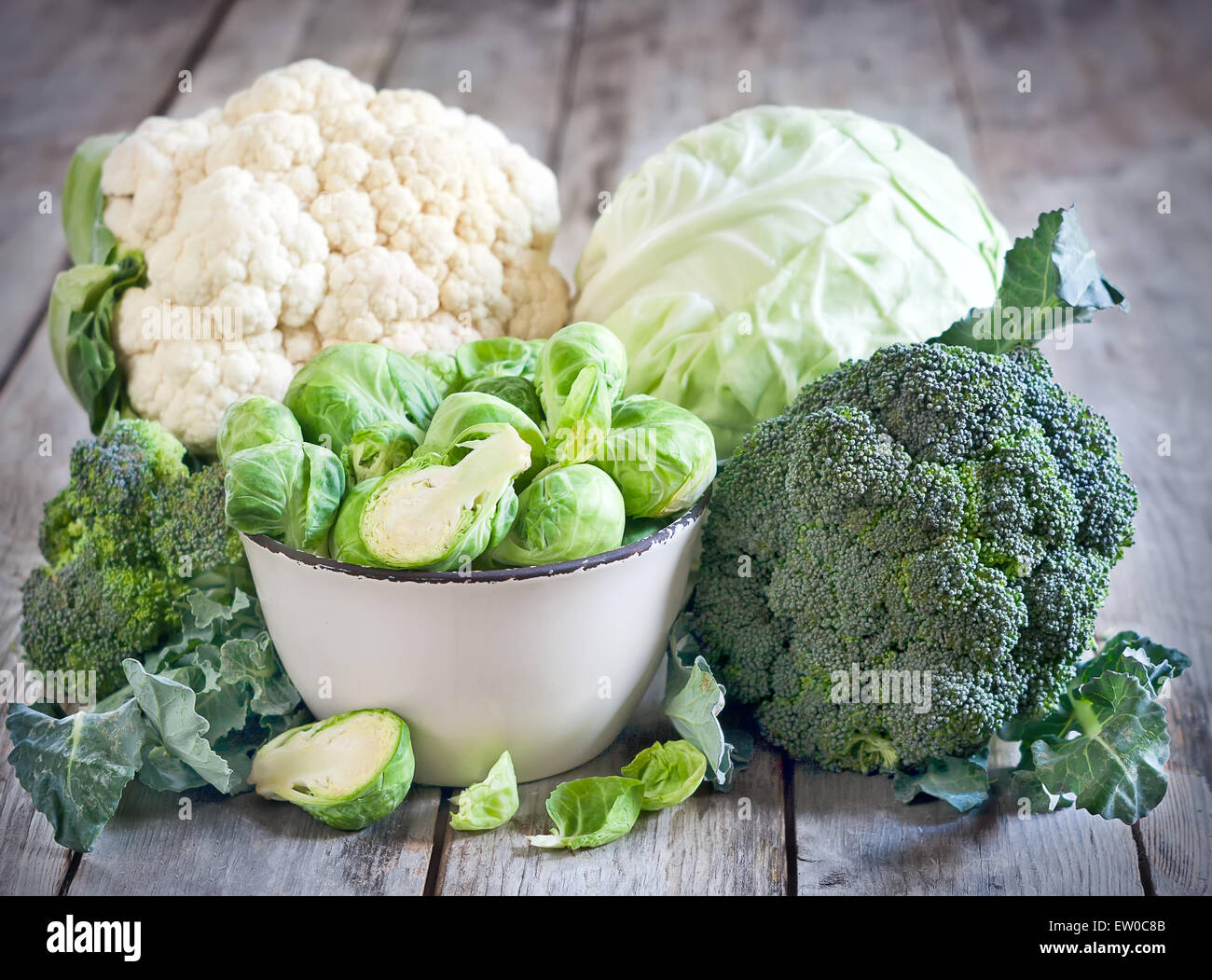 Assortment of cabbages on old wood background Stock Photo - Alamy