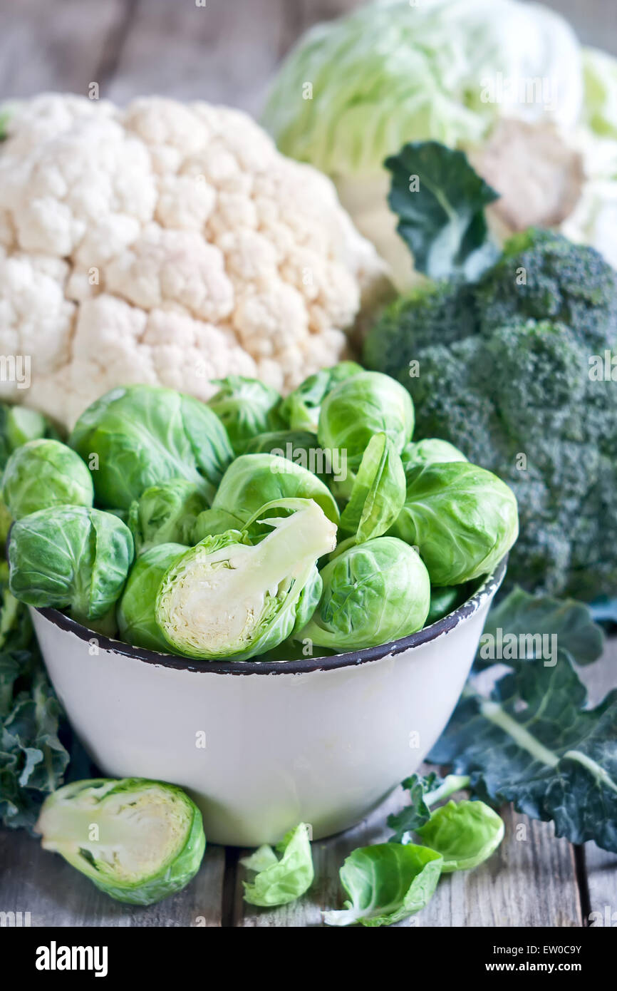 Assortment of cabbages on old wood background Stock Photo - Alamy